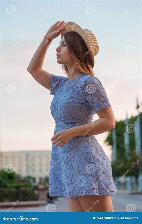 Beautiful Brunette Young Woman Wearing Dress And Walking On The Street