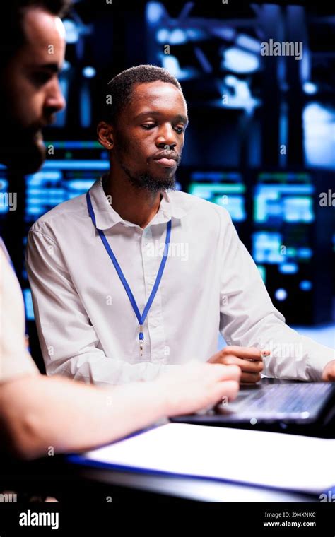 African American Admin And Coworker Dealing With Server Farm System