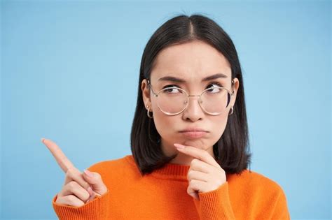 Premium Photo Image Of Thoughtful Asian Woman Frowns Wears Glasses