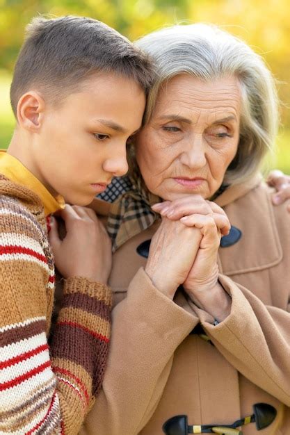 Premium Photo Portrait Of Grandmother And Grandson Hugging In Park