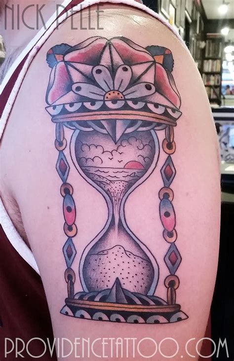 A Womans Arm With An Hourglass Tattoo On It