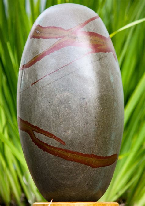 Gray And Red Narmada Shiva Lingam Stone With Stripes Representing Shiva
