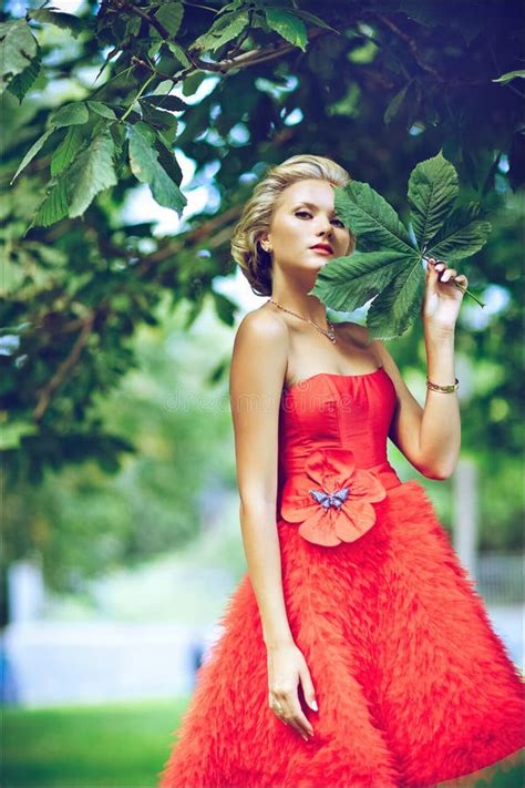 Portrait Of A Beautiful Elegant Sensual Blonde Girl In A Red Dress