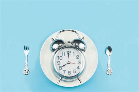 Premium Photo Close Up Of Clock On Table Against Blue Background