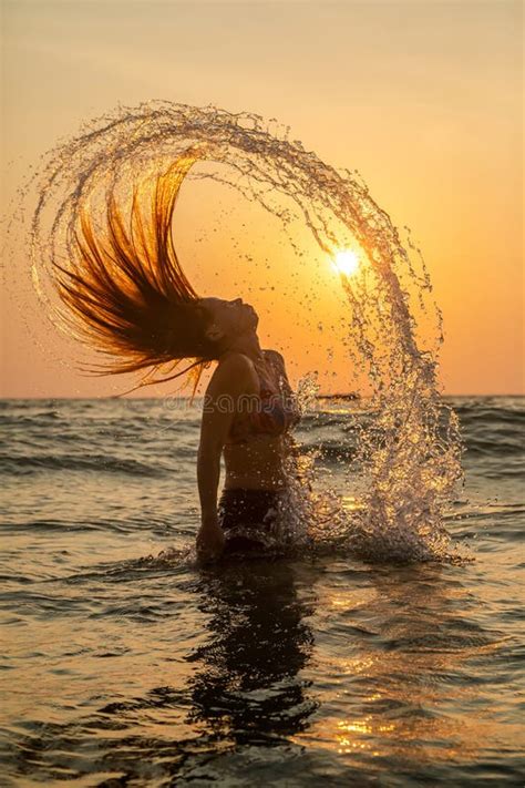 Silhouette Of A Girl With Long Hair In Water Girl Splashing Hair Stock