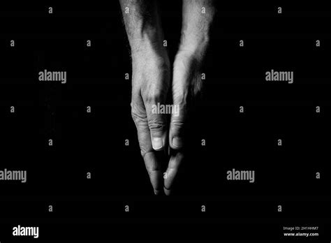 Black And White Image Of Two Male Hands Touching Palms Pressed Together