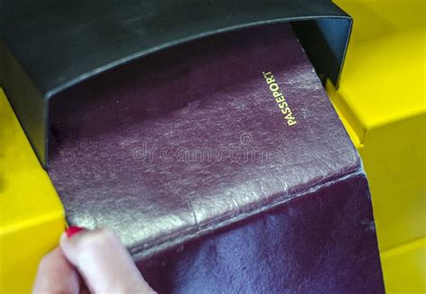 Close Up Of Woman Placing A Generic Passport In A Self Service Scanning Machine At Airport Stock