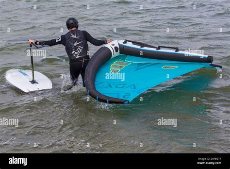 Man Wearing Oneill Wetsuit Carrying Wing Foil Wingfoil Into Sea Ready