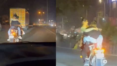 Video बाइक की टंकी पर बैठी लड़की ने खुलेआम किया लड़के को Kiss पुलिस