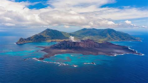 Majestic Volcanic Island Landscape With Vibrant Ocean Waters And Lush