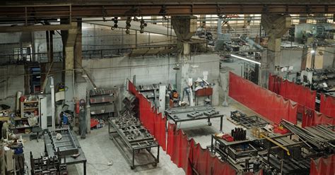 산업 공장 또는 제조소의 넓은 작업장 일부의 각도 위에는 빨간색 커튼으로 구분된 여러 섹션이 있습니다 사진 Unsplash의 작업 이미지