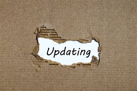 The Word Updating Appearing Behind Torn Paper Updated Laptop Icon Photo Background And Picture