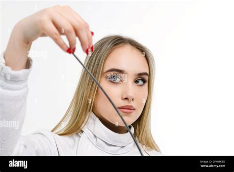A Young Girl Fencer Touches The Tip Of The Sword With Her Palm On A