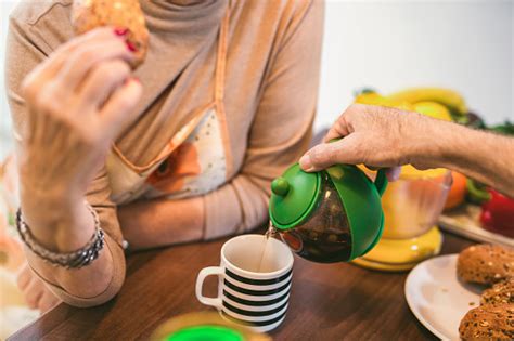 아침 식사를 준비 하는 부엌에서 노인 부부입니다 그들은 커피 또는 차를 마 시와 이야기 2명에 대한 스톡 사진 및 기타 이미지