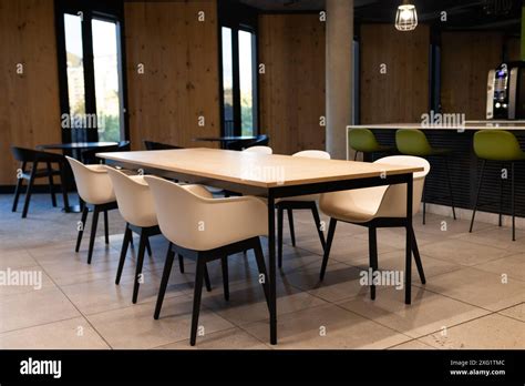 Modern Office Break Room With Empty Chairs And Table Ready For