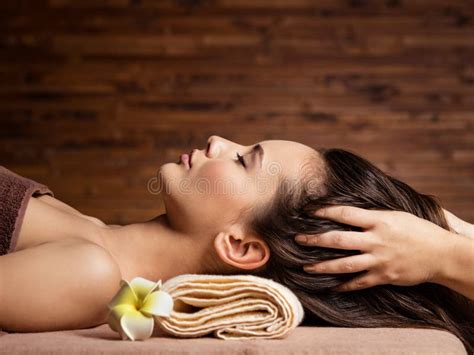 Masseur Doing Massage The Head Of An Woman In Spa Salon Stock Image