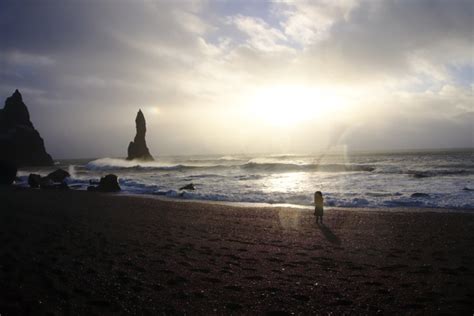Free Back View Photo Of Young Girl Standing Alone At The Beach Looking