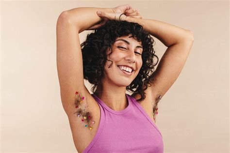 Confident Young Woman Smiling At The Camera While Flaunting Her