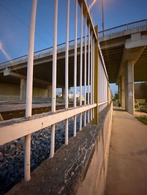 Premium Photo Bridge Over Road By Building Against Sky