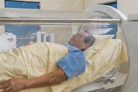 Premium Photo Man Relaxed Inside A Machine For Hyperbaric Treatment