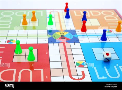 Different Colors Ludo Tokens And Dice On The Ludo Game Stock Photo Alamy