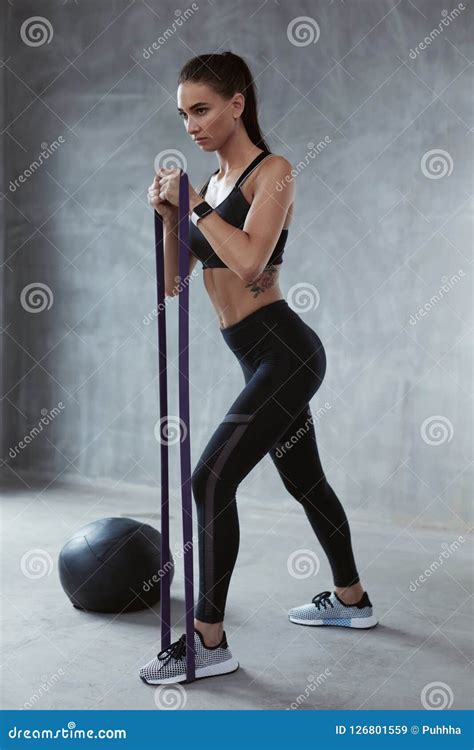 Resistance Band Fitness Woman Doing Squat Exercise For Glutes On The