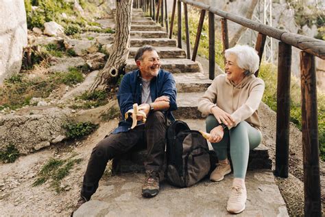 Elderly Couple Having Some Bananas While Sitting At The Bottom Of A