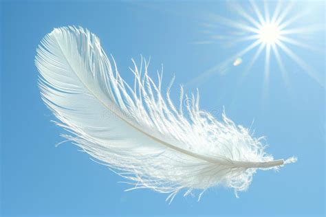 White Feather Floating Against Clear Blue Sky With Bright Sunlight