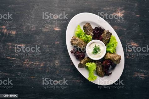 박제 포도 나무 잎 Dolma Sarma Dolmadakia Dolmades 흰색 접시 에 오래 된 나무 배경 텍스트에 대 한