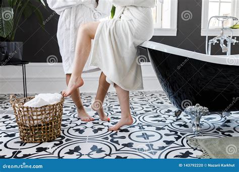 Cute Young Two Women Dressed In White Dressing Gowns And Towels On The