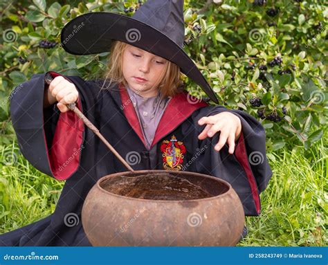 Halloween A Girl In A Robe And Hat A Little Sorceress In The Costume
