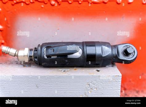 Close Up Air Ratchet Wrench Angular Pneumatic Wrench On A Gray Close Up Air Ratchet Wrench Angular Pneumatic Wrench On A Gray