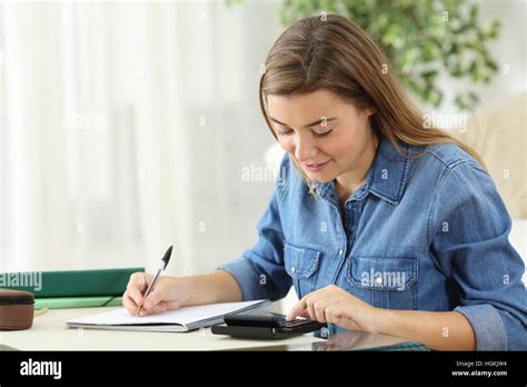 Babe Studying Calculating With A Calculator And Handwriting Notes Siting On The Floor In The