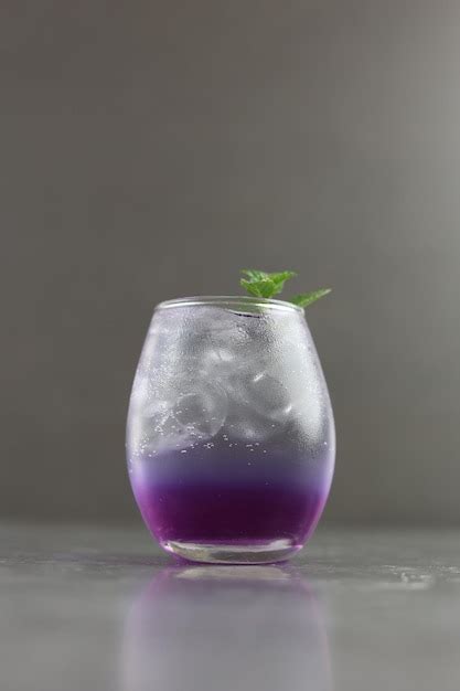 Premium Photo Purple Butterfly Pea Iced Soda With Mint Leaf Topping