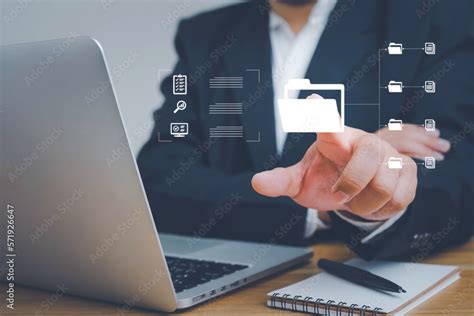 document management system concept businessman pointing folder icon on