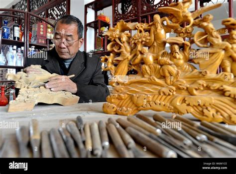 57 Year Old Chinese Craftsman Wang Sijun Craves A Wooden Figure Of A