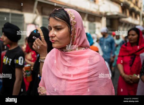 A Sikh Woman In Traditional Clothing During The Procession For The