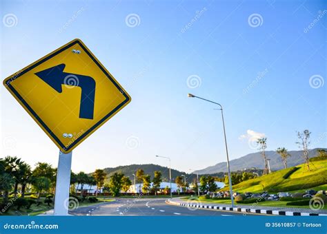 Turn Left Sign On The Road Warning Signs And Orange Safety Traffic