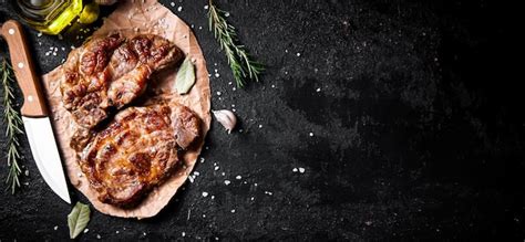 Premium Photo Grilled Pork Steak On Paper With Rosemary