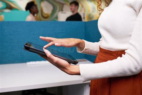 Close Up Cropped Shot Of Hands Swiping On Digital Tablet Colleagues In Office Stock Photo