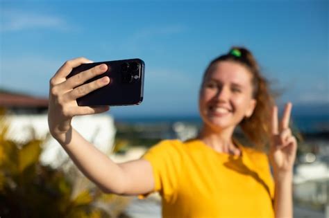 Premium Photo Young Beautiful Happy Woman Blogger Is Taking Selfie