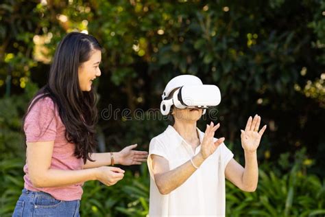 Using Vr Headset Asian Grandmother Exploring Virtual Reality With Daughter Outdoors Stock Photo