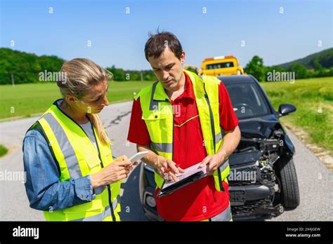 Roadside Assistance Worker Filling Out Paperwork On A Clipboard With