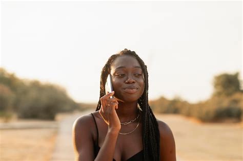 Premium Photo A Young Black Woman With Braids In Her Hair Happily
