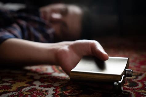 The Man Passed Out From An Overdose Of Alcohol Fall To The Floor Flask