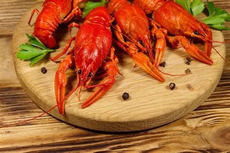 Premium Photo Boiled Crayfish On Cutting Board On Wooden Table