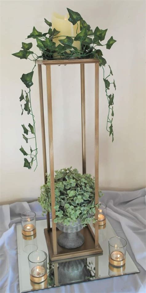 Tall Minimal Centre Piece With Candle Trailing Ivy And Small Urn With