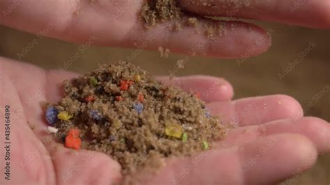 Stockvideo Microplastics On Sandy Beaches Tiny Multicolored Plastic Bits In Sand Microplastic