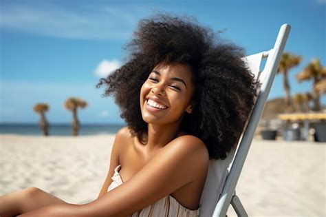 Premium Photo Smiling Black Woman Sitting On A Chair On The Beach