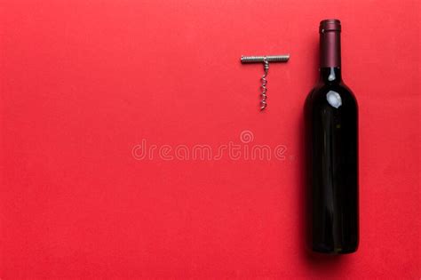 One Bottle Of Red Wine With Corkscrew On Colored Table Flat Lay Top